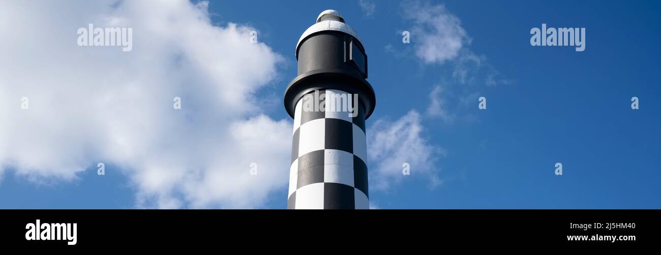 Lighthouse with black and white chequer design Stock Photo - Alamy