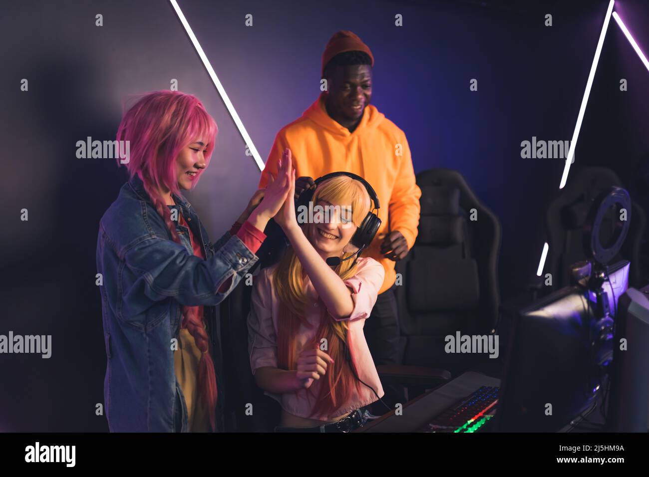 High five. Young female beginner gamer is happy after her first win ...