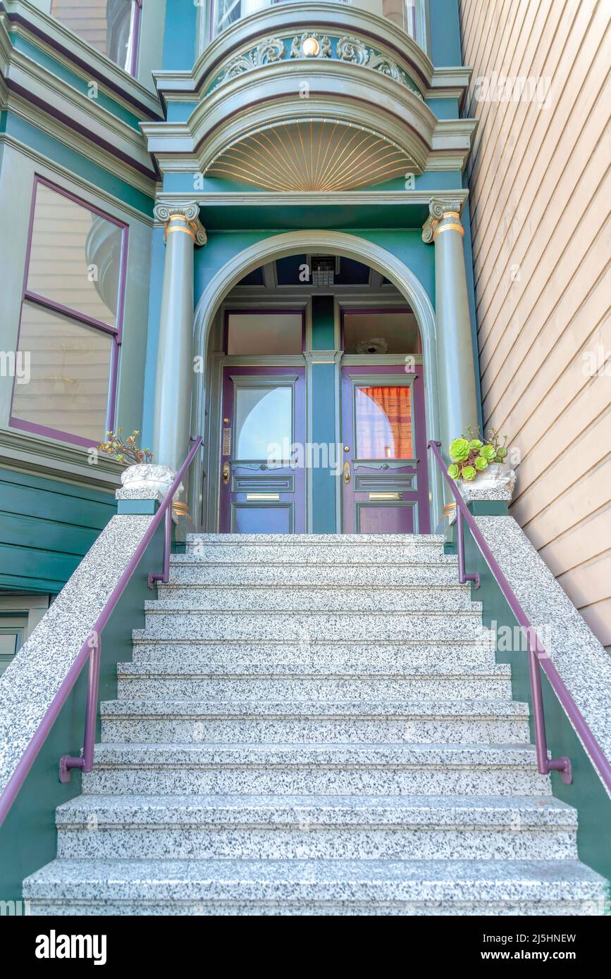 Victorian style townhouse entrance exterior with concrete stairs and ...