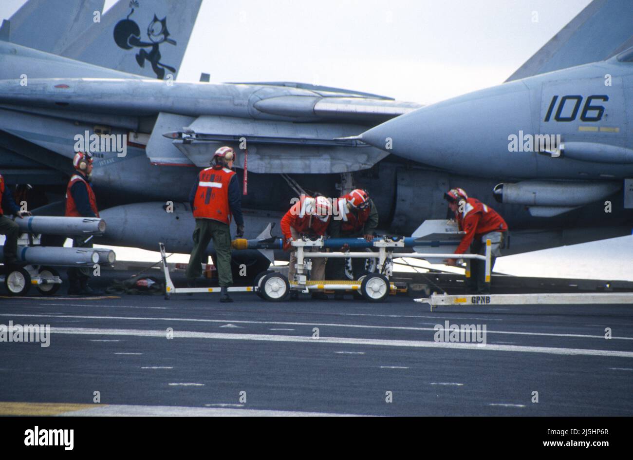 Armorers preparing F-14's for flight ops aboard aircraft carrier Stock ...