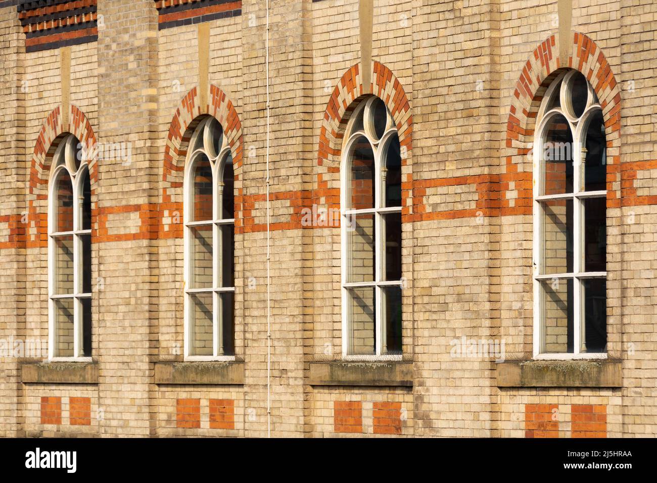 Windows and exterior wall of old train station in the city. Manchester ...