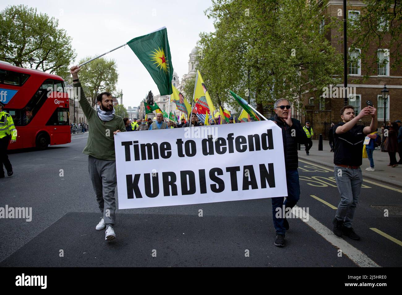 Protesters march holding a banner during the demonstration. A group of ...