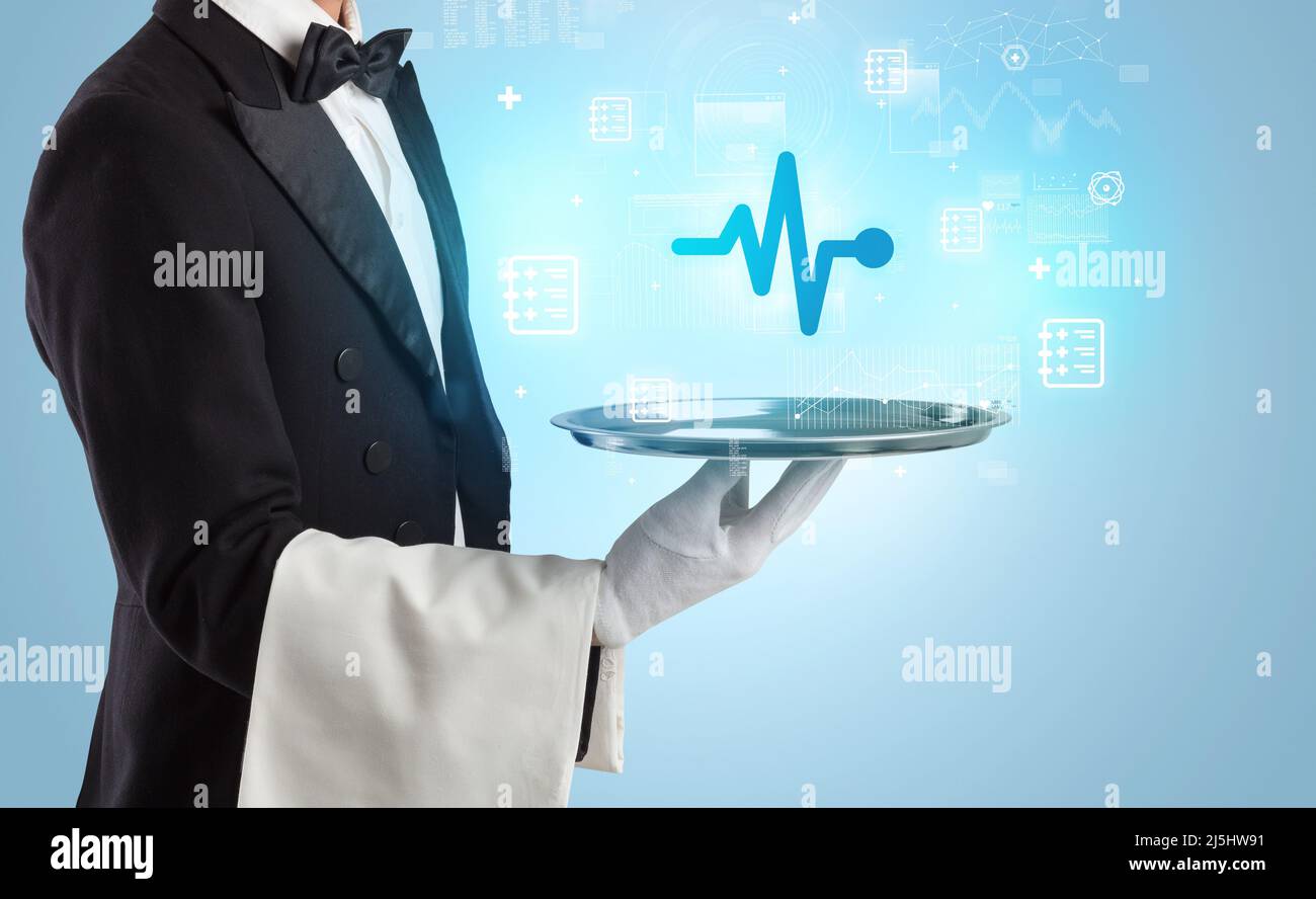 Handsome young waiter in tuxedo holding healthcare icons on tray Stock ...