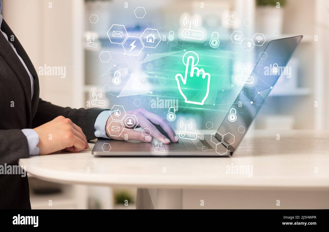 Hands working on laptop with digital icons Stock Photo - Alamy