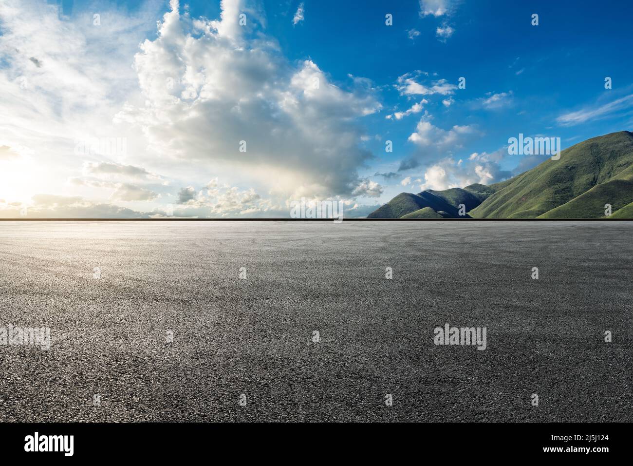 Empty asphalt road platform and beautiful blue sky with white clouds at ...