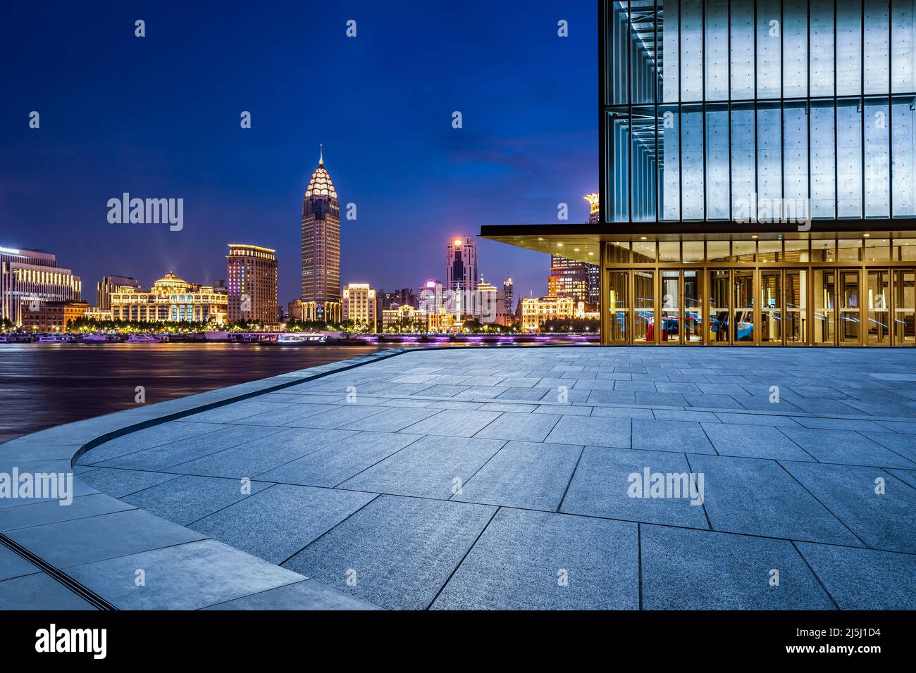 Empty square floor and city skyline with buildings in Shanghai at night ...