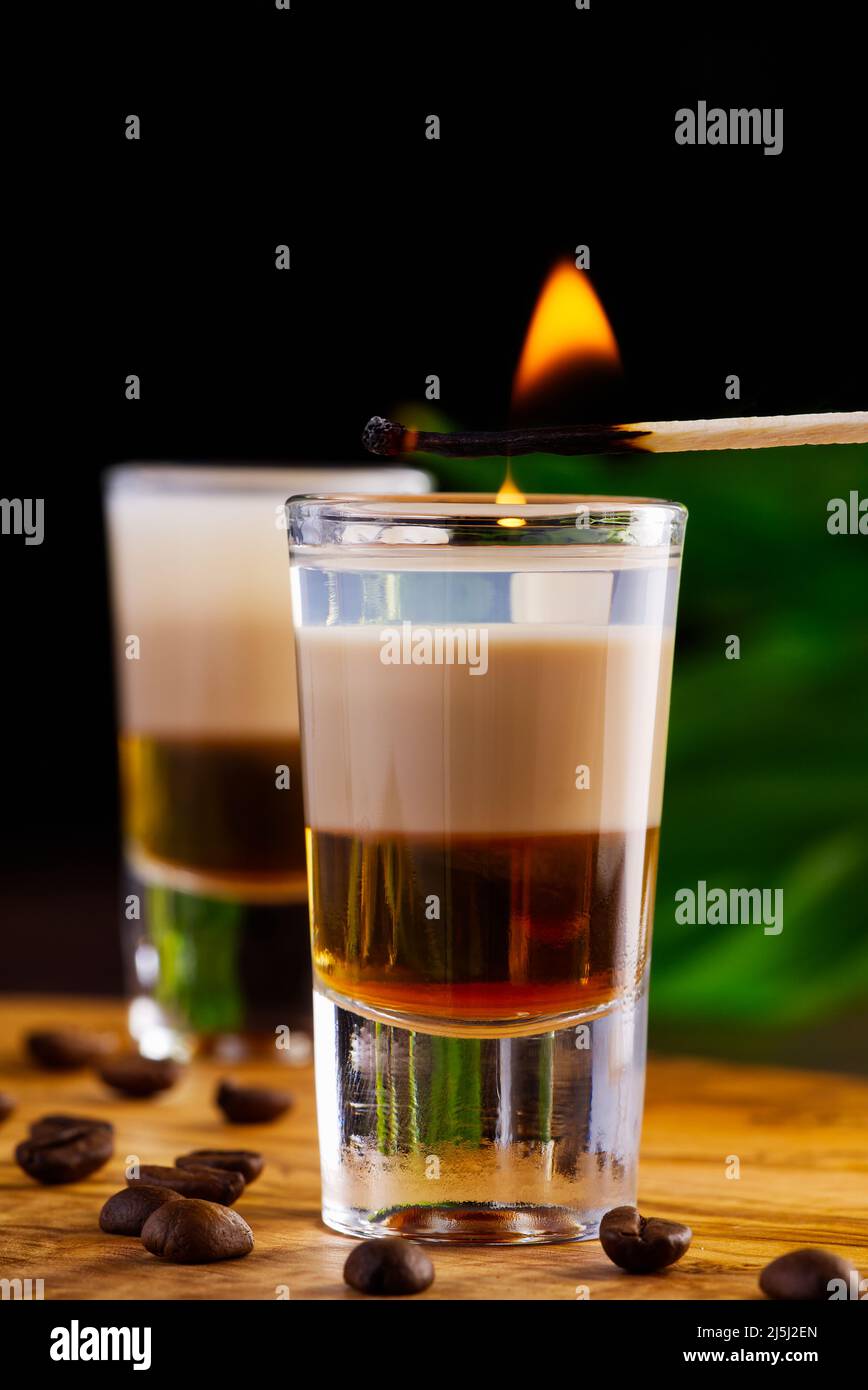 Shots of flaming B-52 cocktail placed on a bar counter. B-52 shot ...