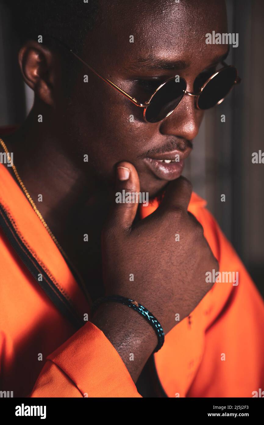 Black prisoner is wearing glasses and a necklace Stock Photo - Alamy