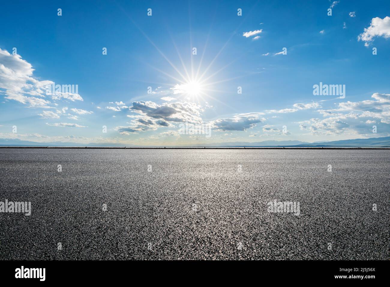 Asphalt road platform and clouds with sun landscape Stock Photo - Alamy