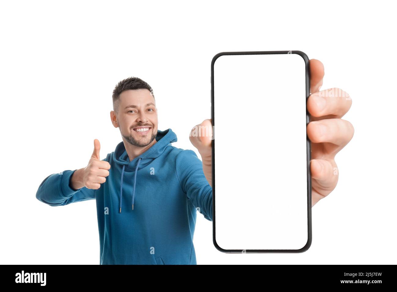 Happy man showing mobile phone with blank screen on white background ...