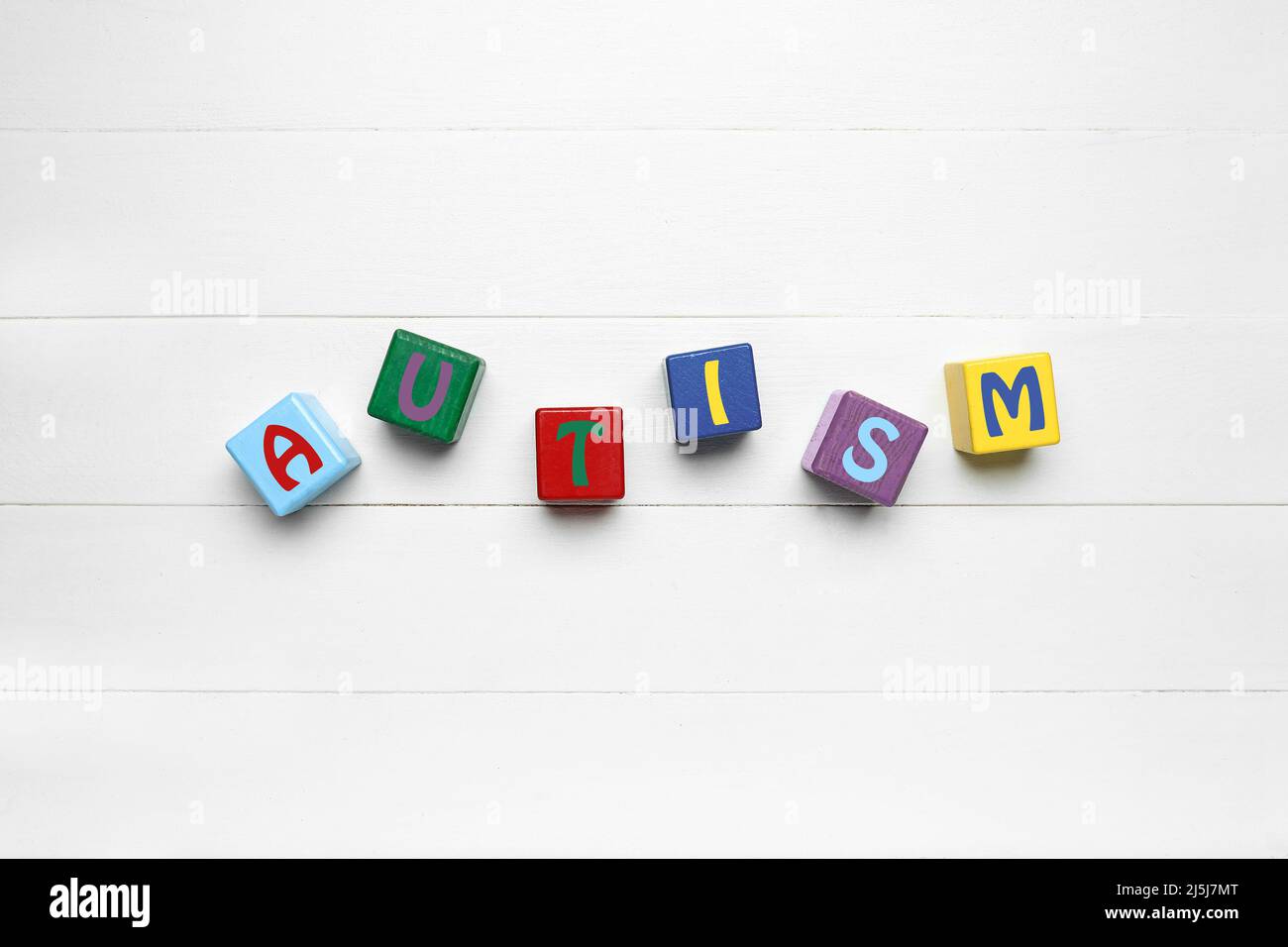 Word AUTISM made of cubes on white wooden background Stock Photo - Alamy