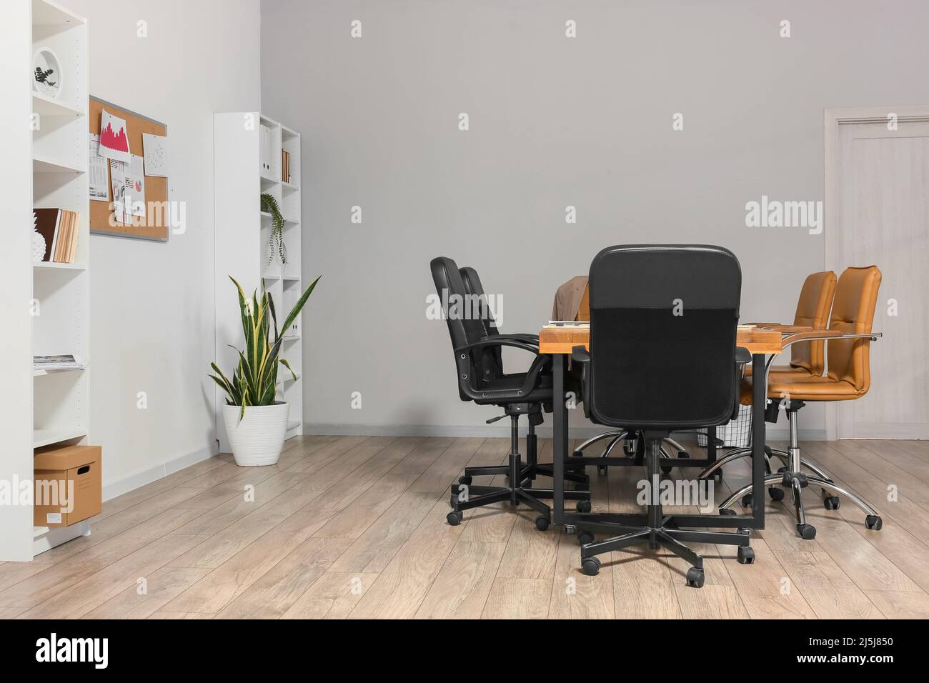 Interior of conference hall with table, chairs and shelf units Stock ...