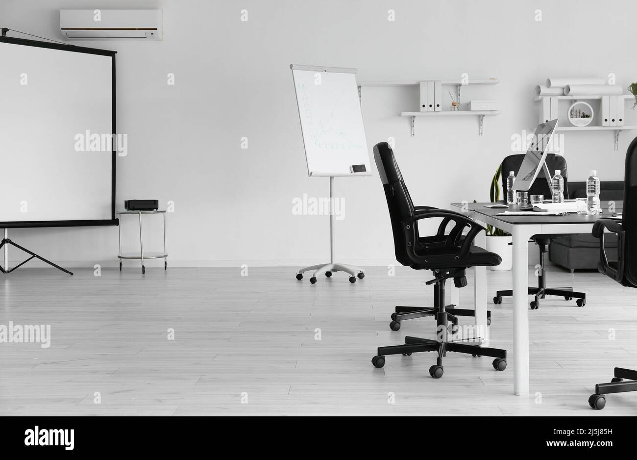 Table with modern computer and chairs in conference hall interior Stock ...