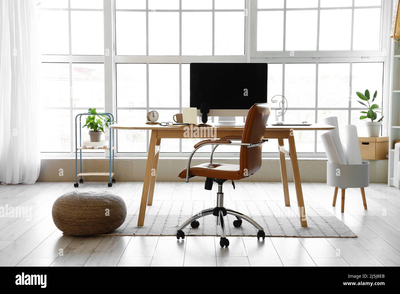 Workplace with modern computer in light room interior Stock Photo - Alamy