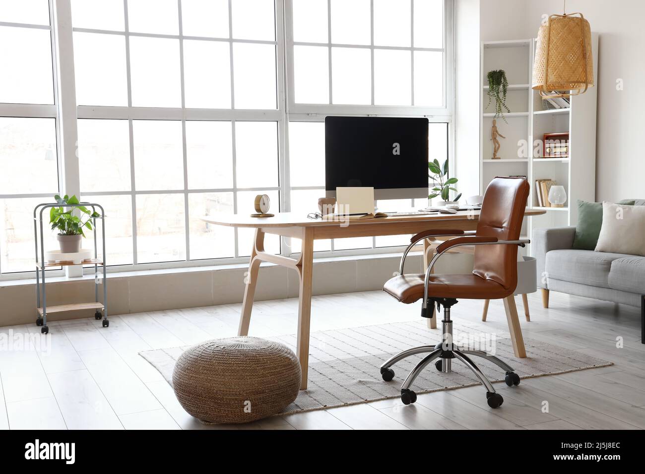 Workplace with modern computer in light room interior Stock Photo - Alamy