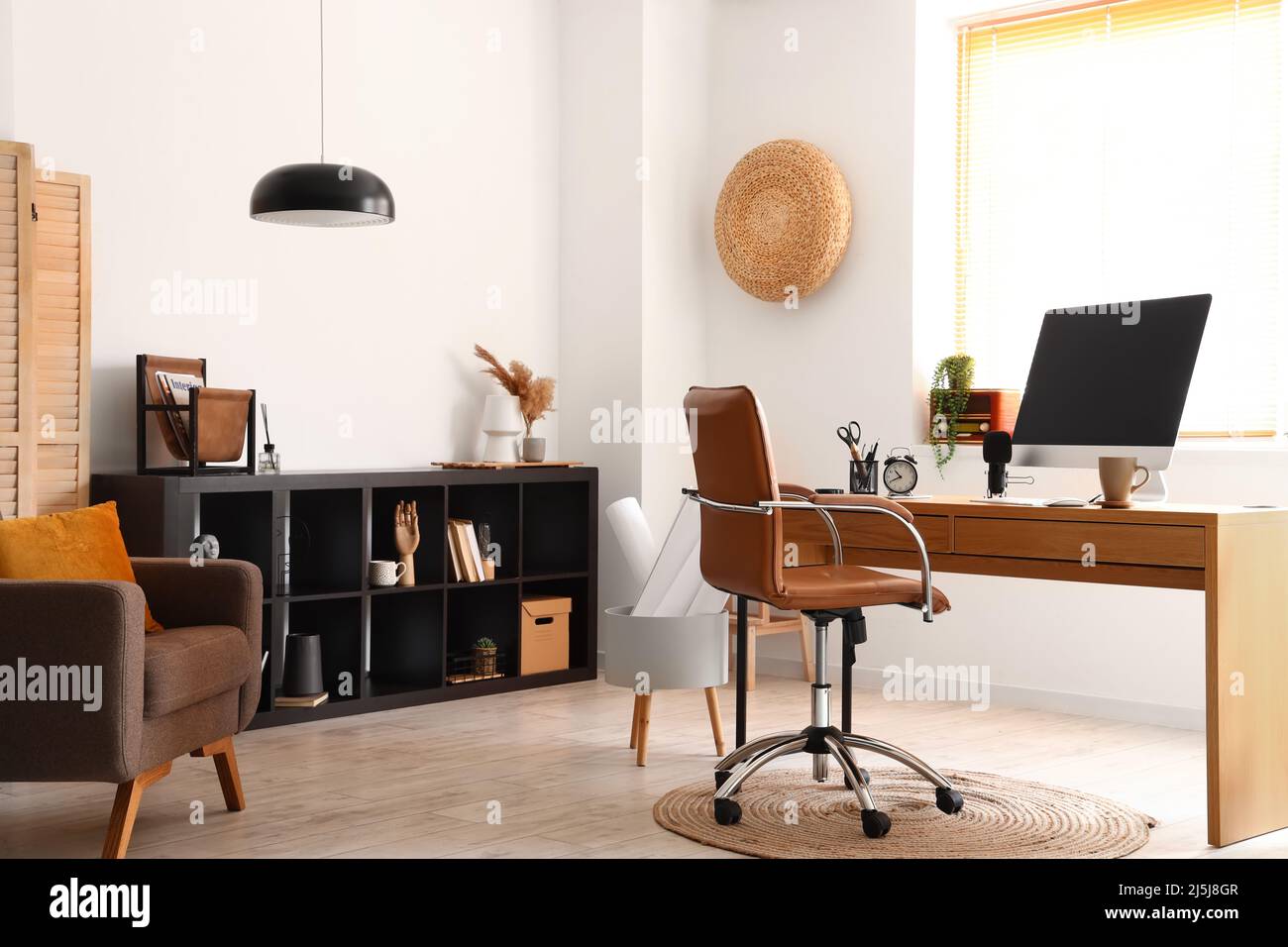 Stylish interior of light room with modern workplace Stock Photo - Alamy