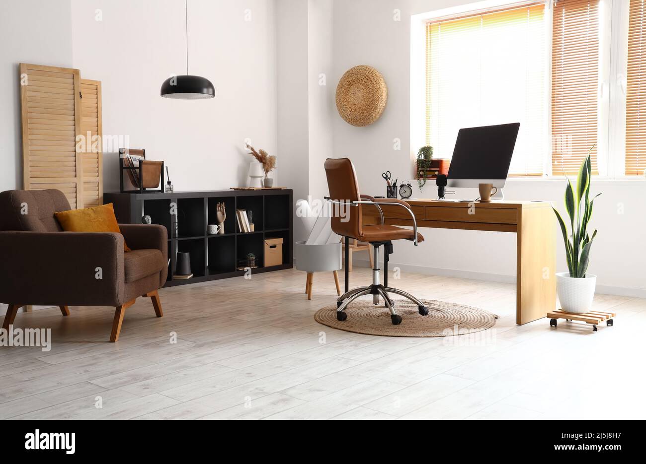 Stylish interior of light room with modern workplace Stock Photo - Alamy