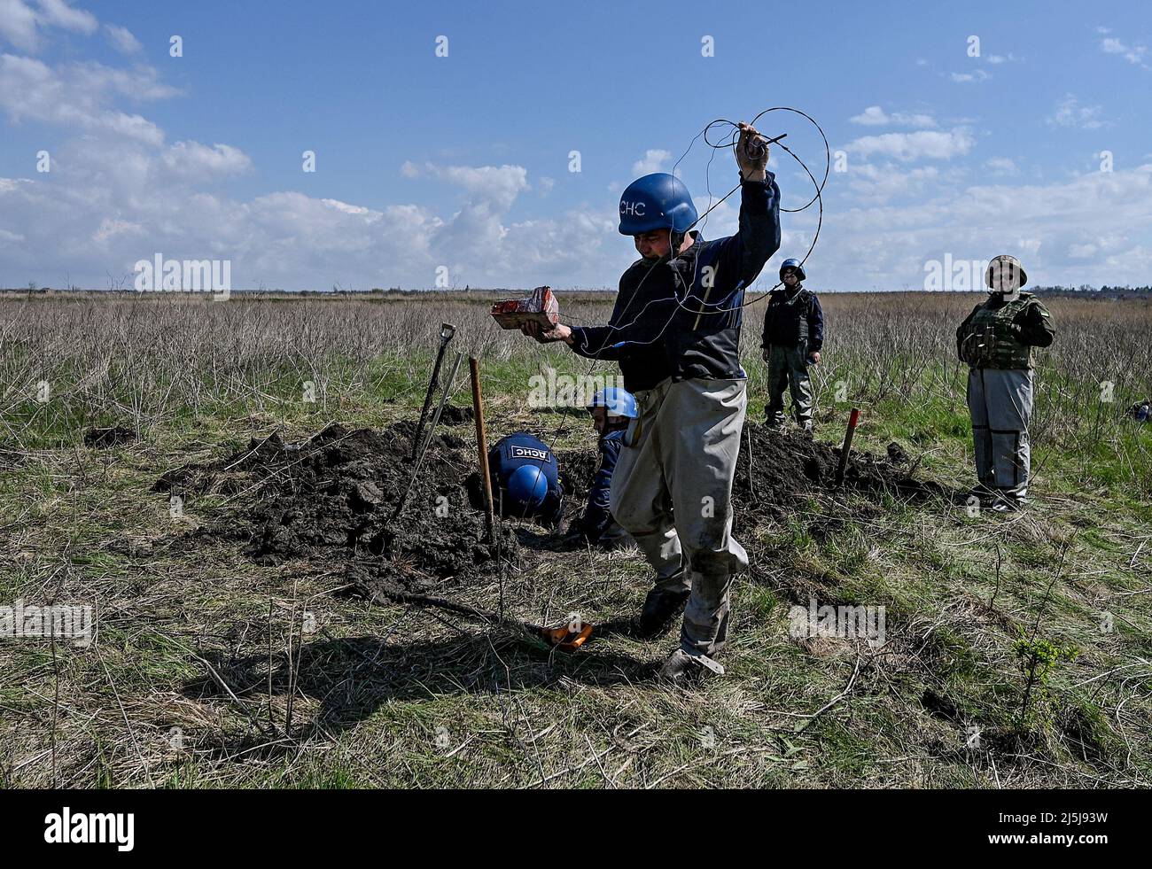 An expert of a State Emergency Service bomb squad rolls out the wire ...