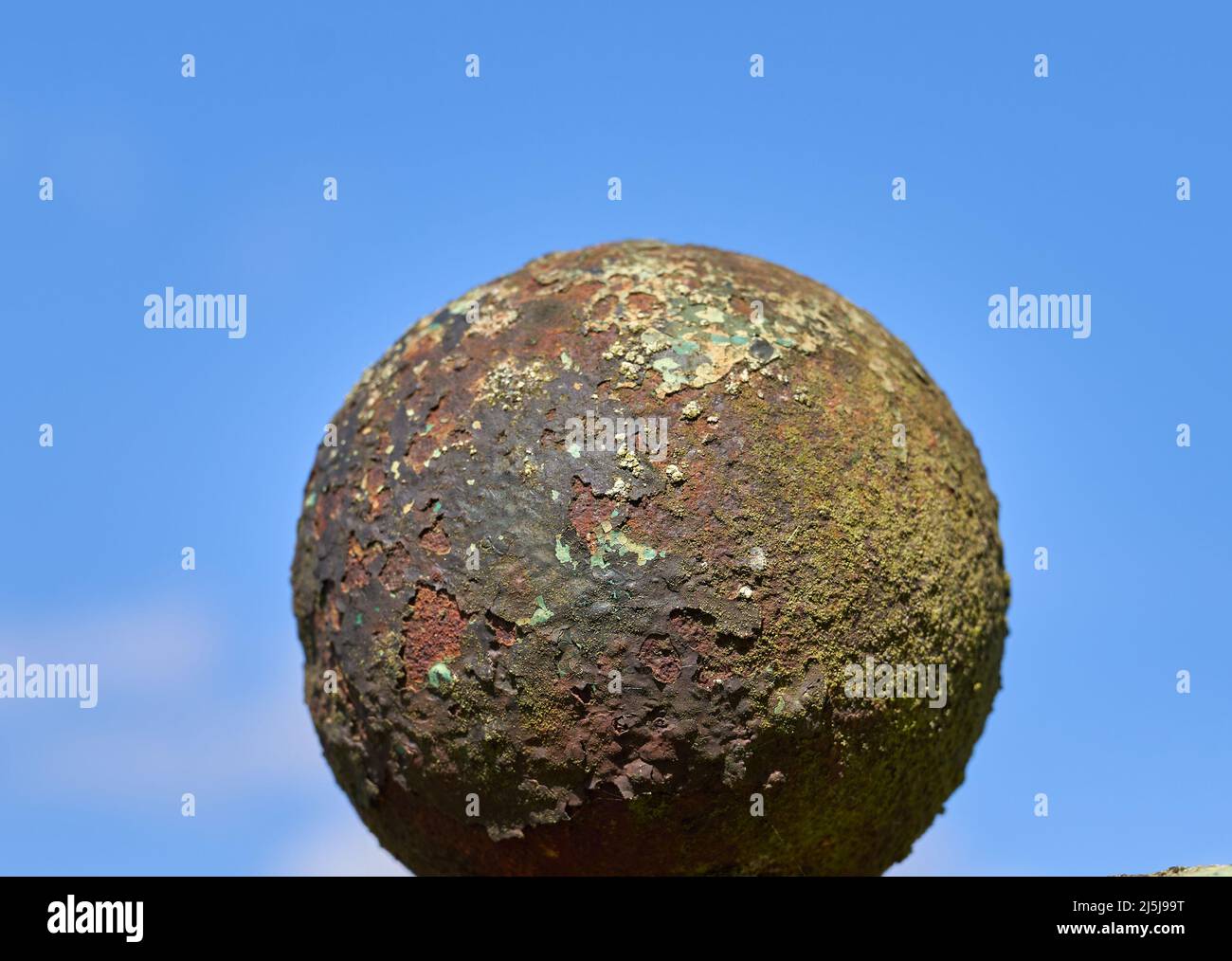 Rusty ornamental cast iron ball Stock Photo - Alamy