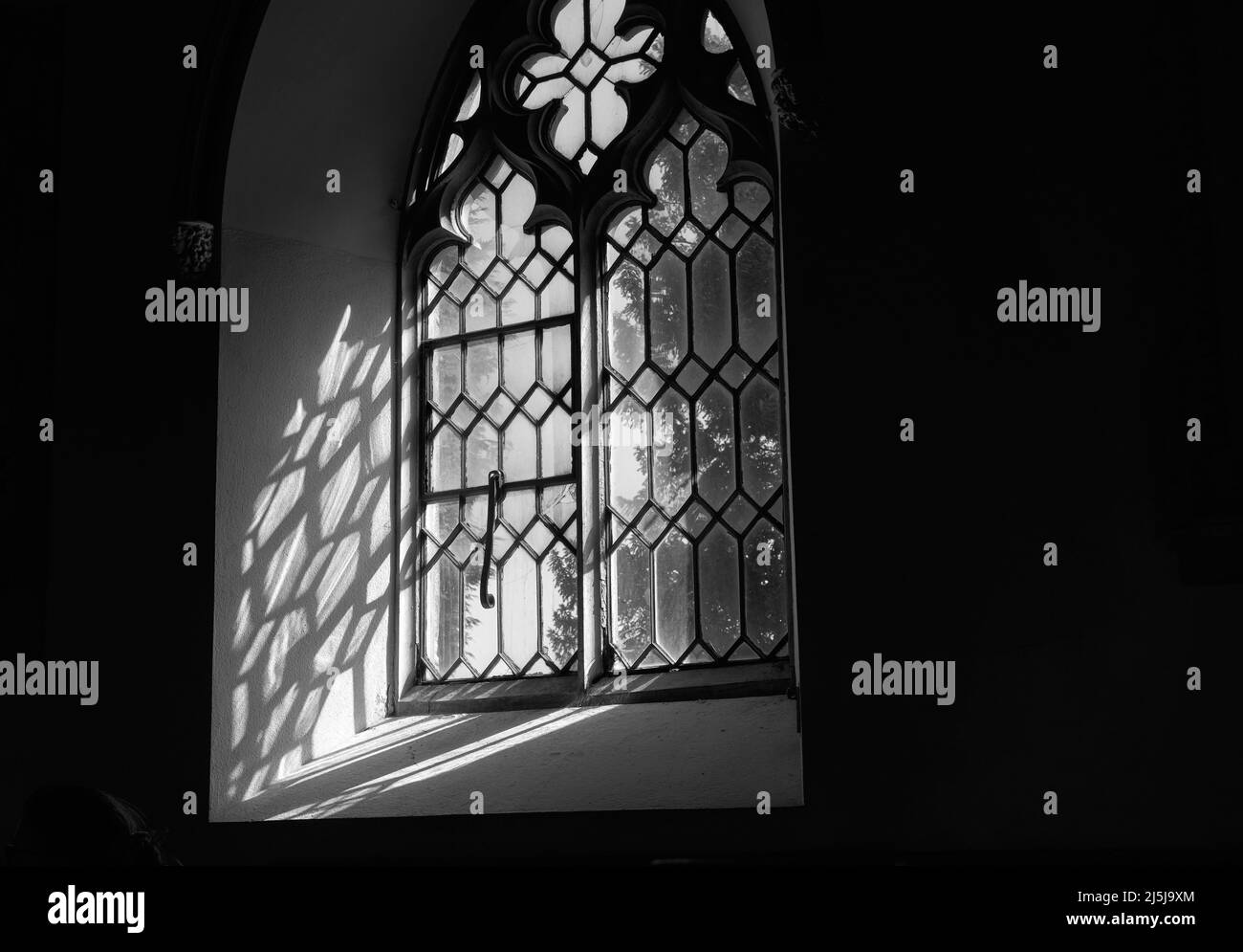 Old church window casting shadows in sunlight Stock Photo - Alamy