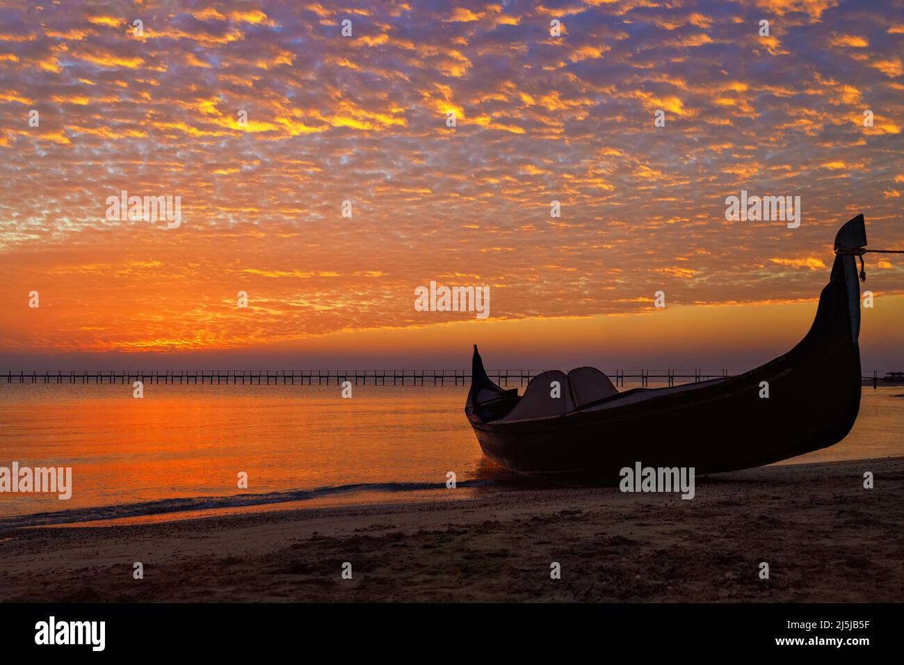 boat standing on the beach during beautiful sunset Stock Photo - Alamy