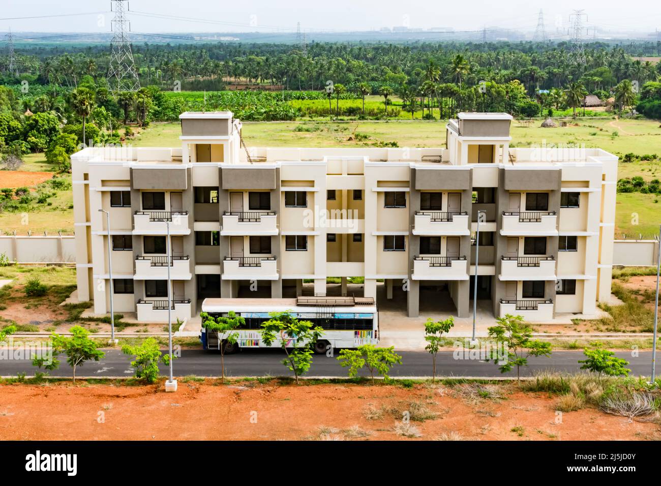 Top view of an Indian colony with bitumen road inside parking a bus ...