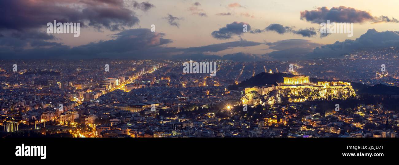 Athens, Greece. Acropolis and Parthenon temple illuminated at night. Ancient ruins, aerial ...
