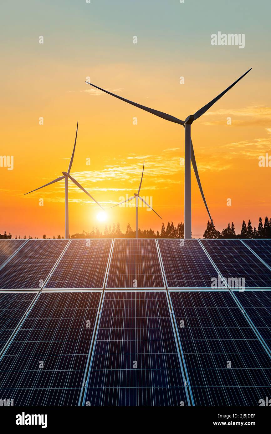 Wind turbines and solar panels at sunset. renewable energy concept ...