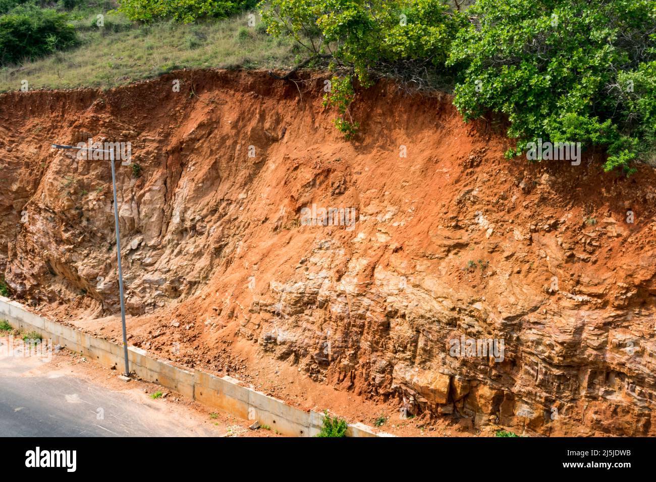mountain edge looking sharp after slide in heavy rain with greenery ...