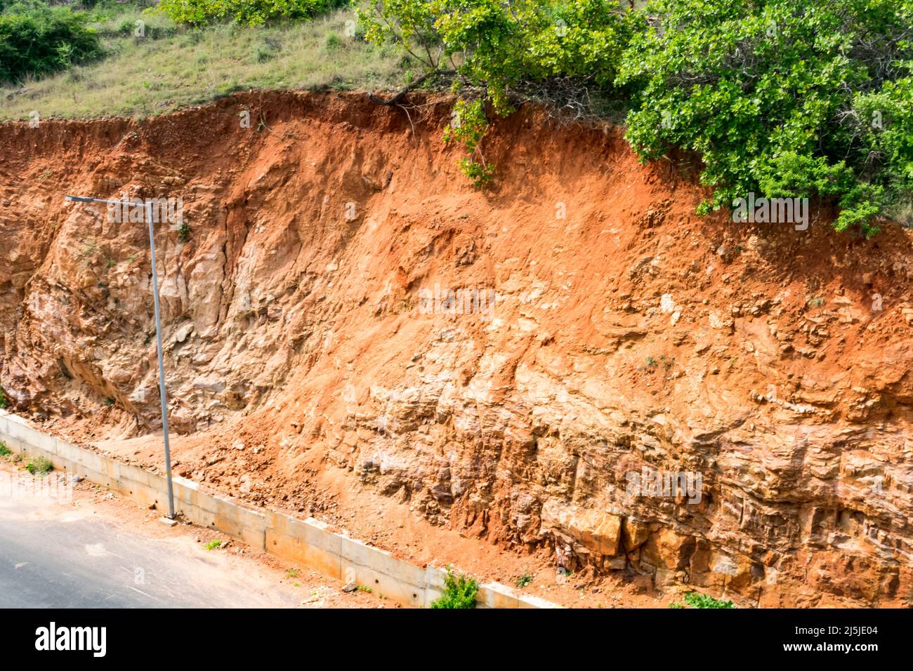 mountain edge looking sharp after slide in heavy rain with greenery ...