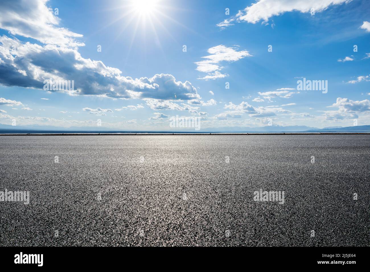 Asphalt road and sky clouds with sun landscape Stock Photo - Alamy
