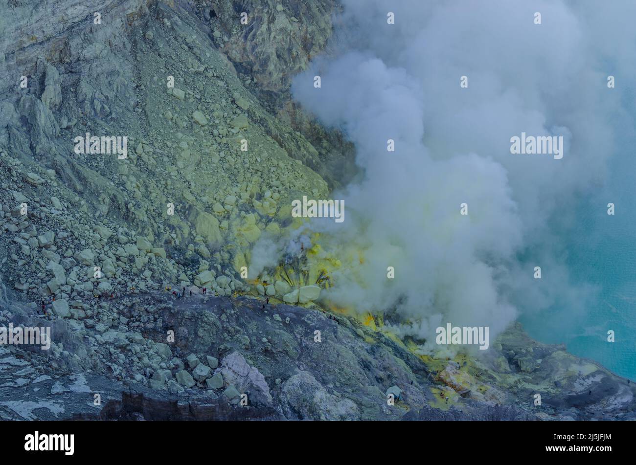 smoking volcano with sulfur and worker Stock Photo - Alamy