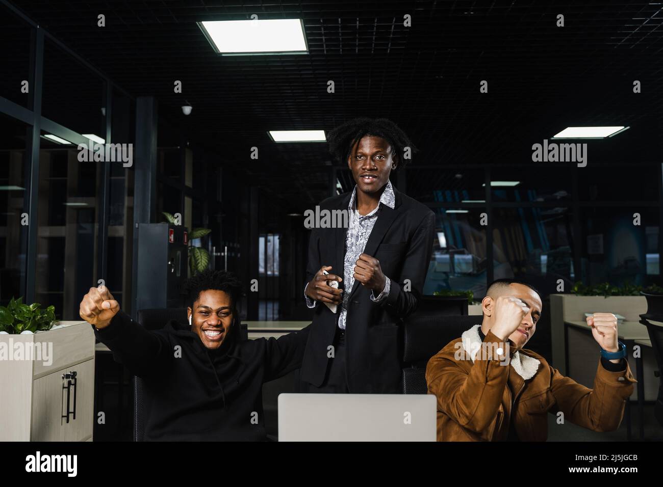 Emotional and joyful black Africans and Asians teamwork together and rejoice at end of online ...