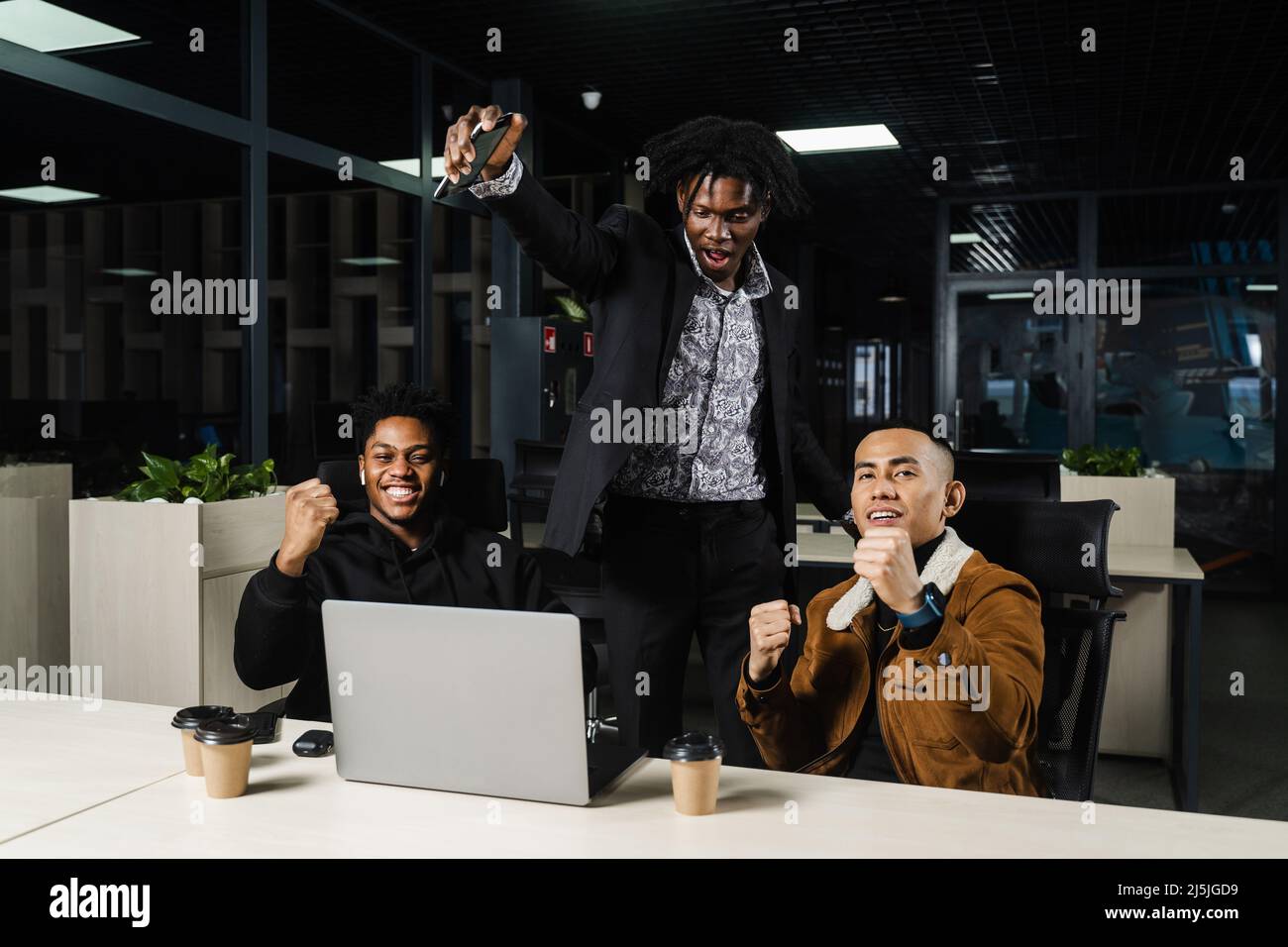 Teambuilding black Africans and Asians. Positive mixed race colleagues ...