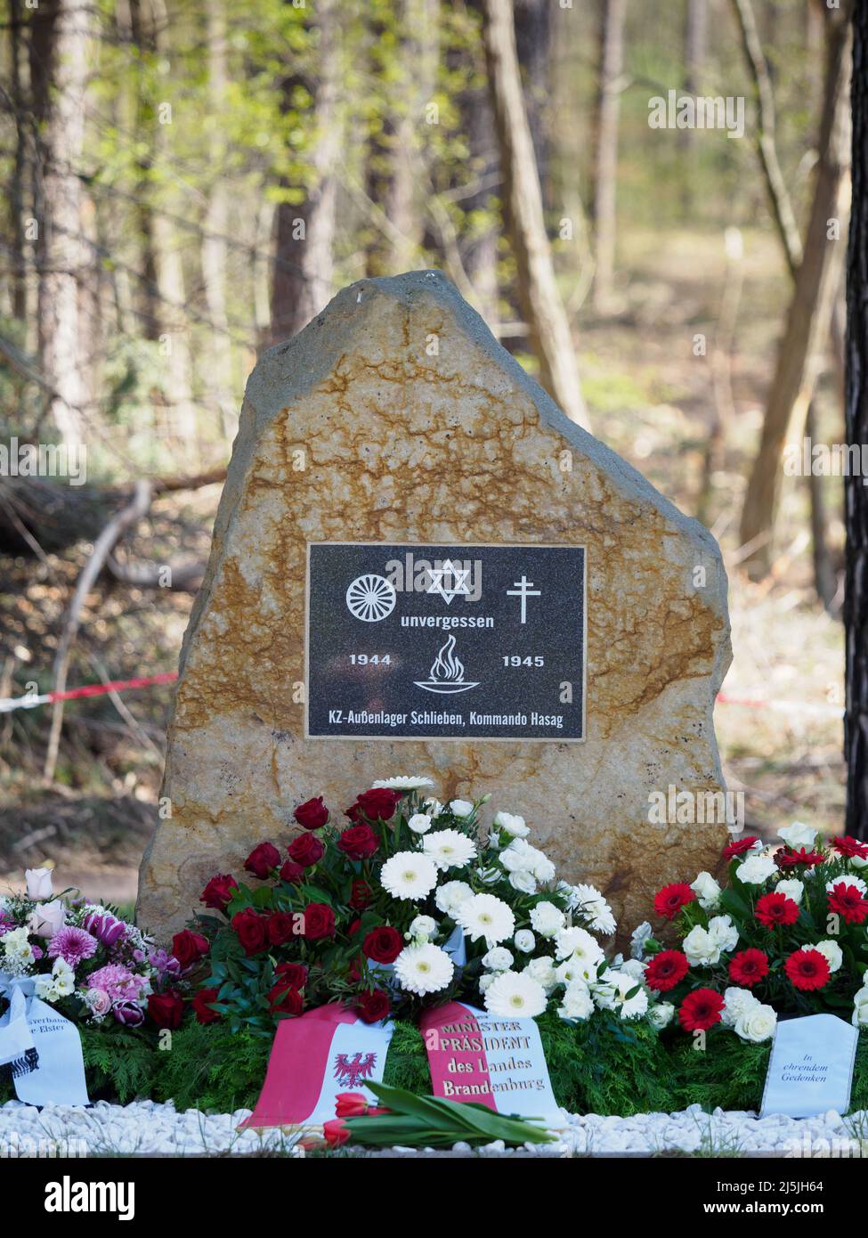 23 April 2022, Brandenburg, Schlieben: A memorial stone stands on the ...