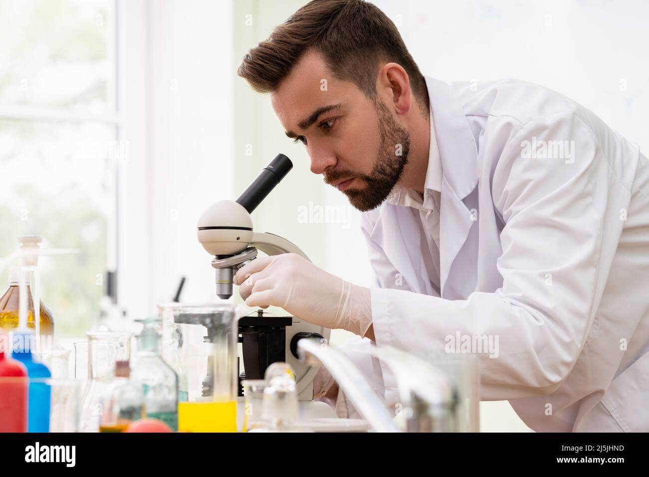Scientist is using microscope in a laboratory during research work Stock Photo - Alamy