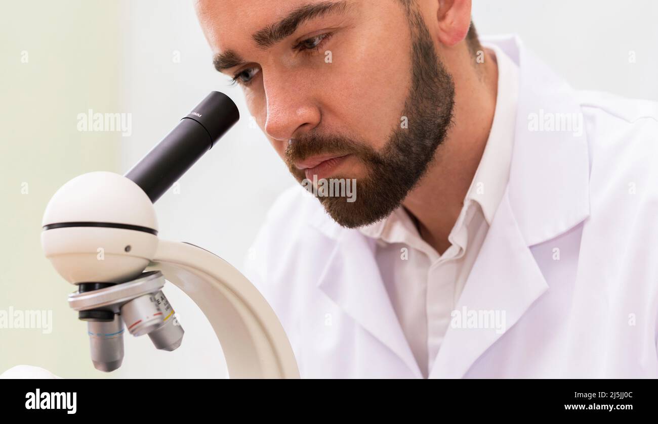 Scientist is using microscope in a laboratory during research work ...