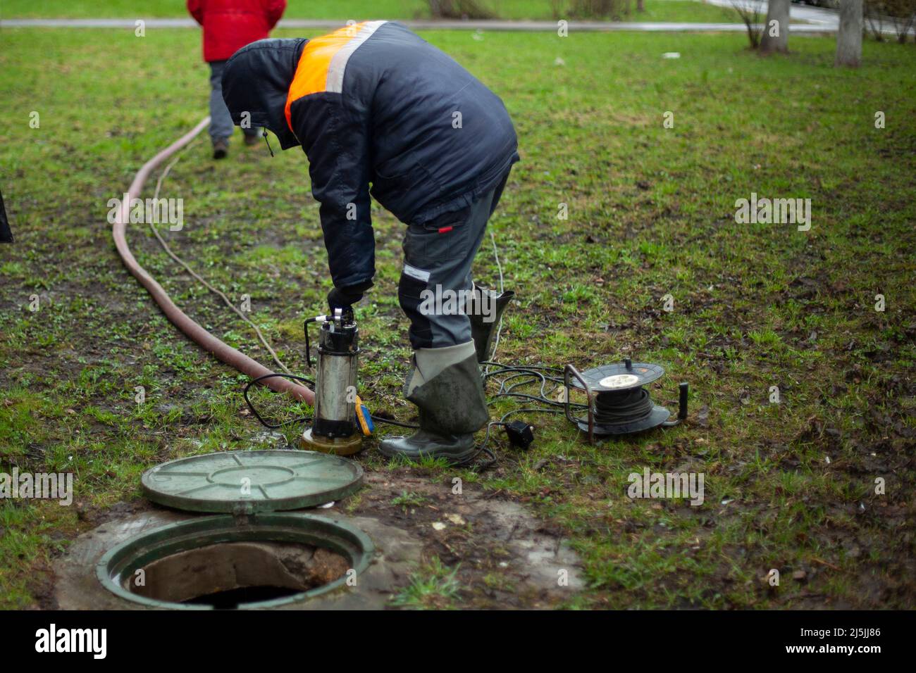 Repair of heating pipes. Workers near the manhole. Equipment for ...