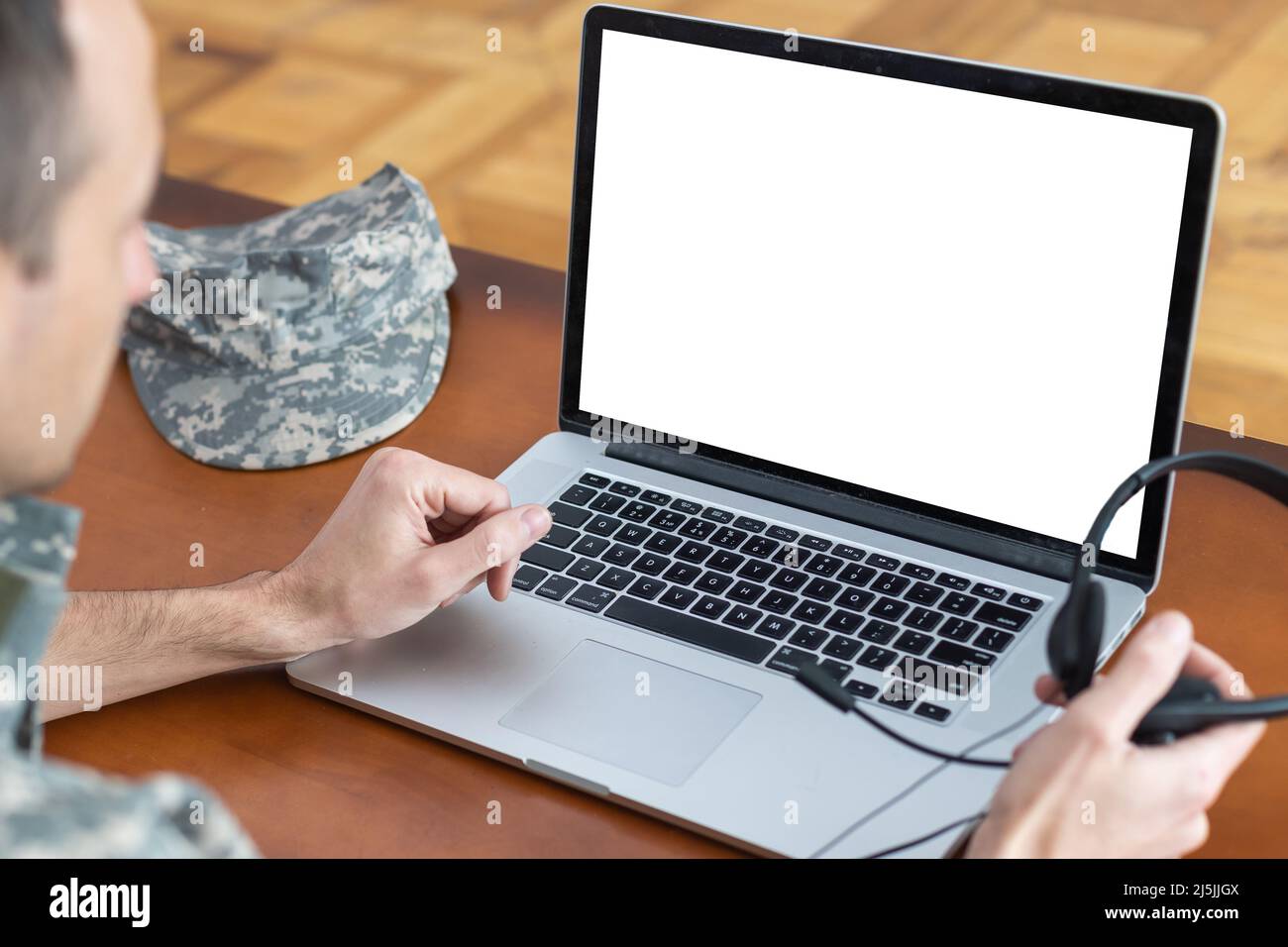 Army. Young soldier working with a laptop computer with blank screen on ...