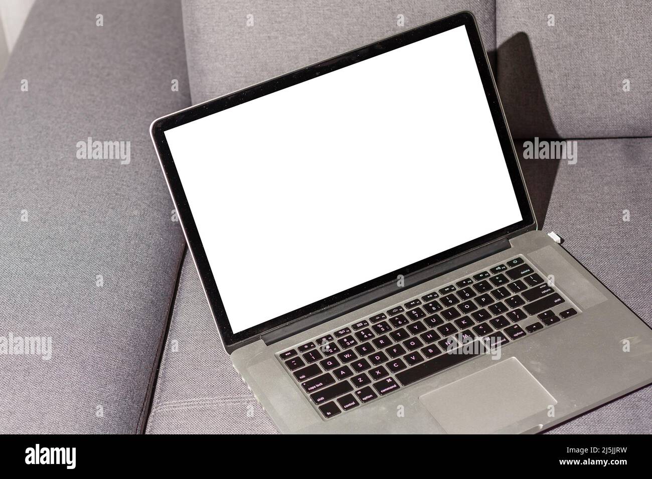 Mockup blank screen laptop on couch in living room Stock Photo - Alamy