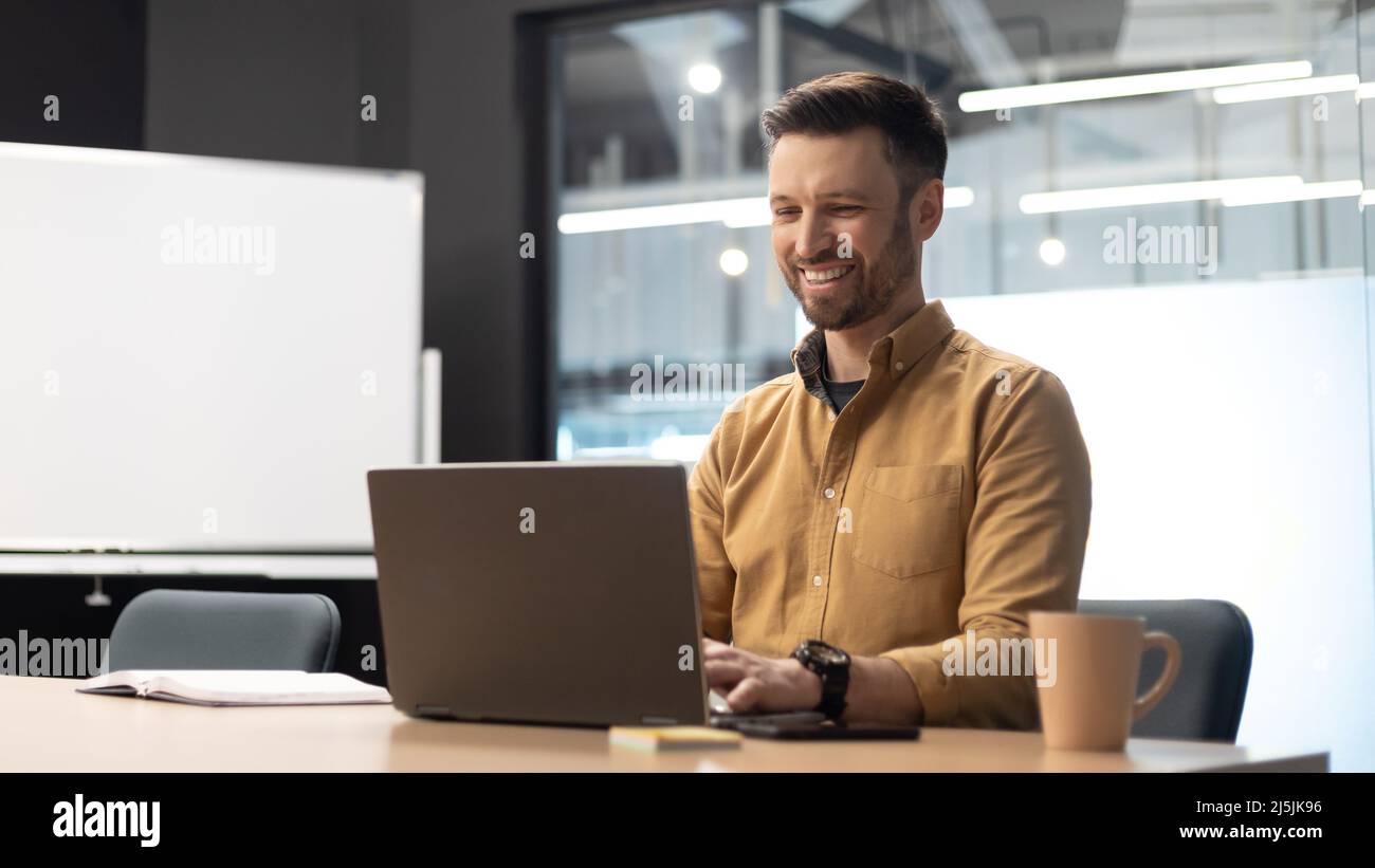 Male Entrepreneur Using Laptop Typing Working Online At Workplace ...