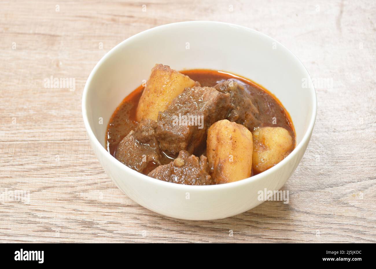 beef meat massaman curry with slice potato and onion in bowl Stock ...