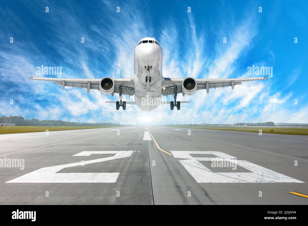 Airport runway number 28 and airplane take off to in horizon and ...