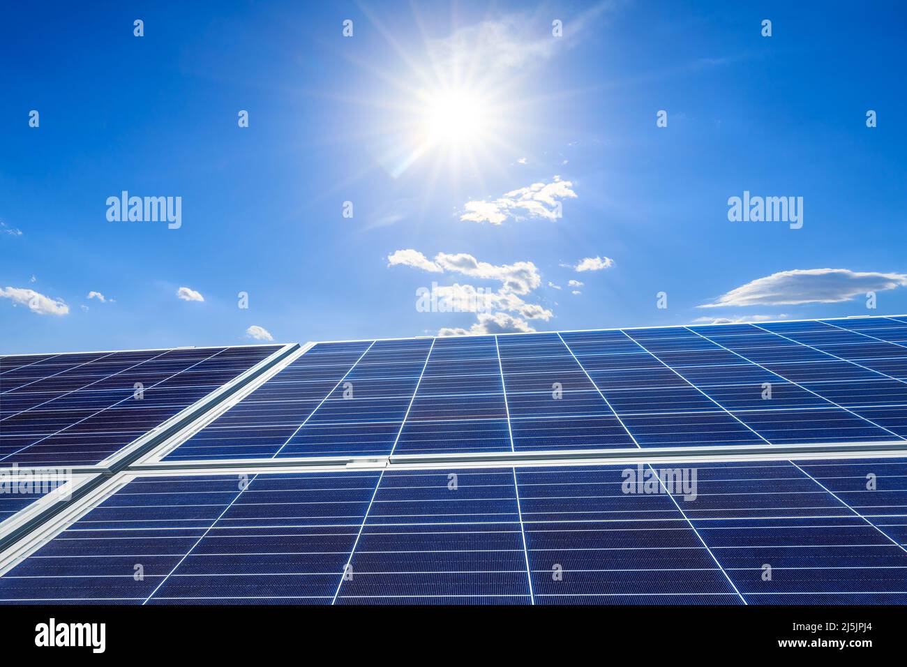 Solar panels and blue sky with sun. Renewable Energy Concept Stock ...
