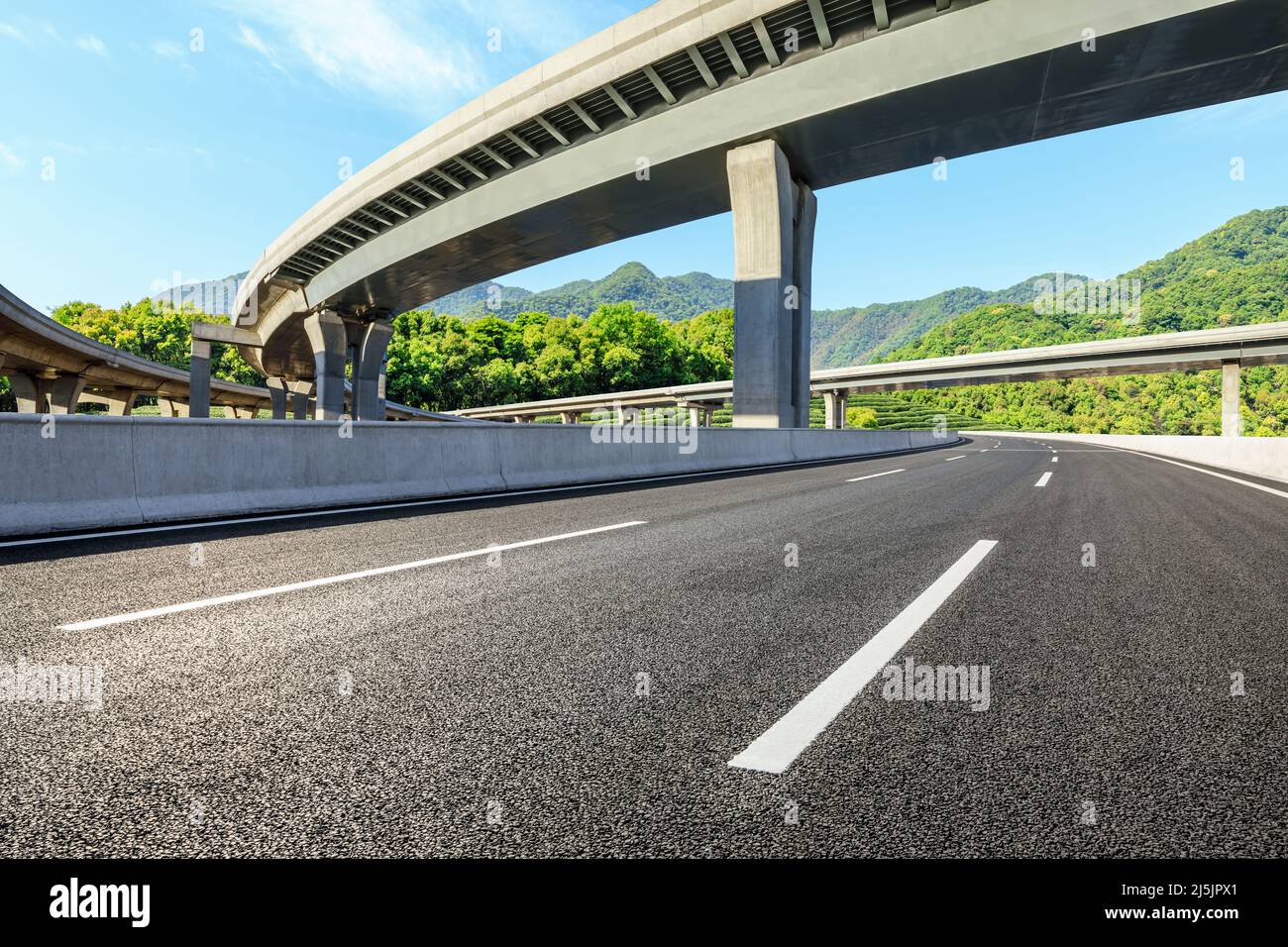 Empty asphalt road and bridge with mountains background Stock Photo - Alamy