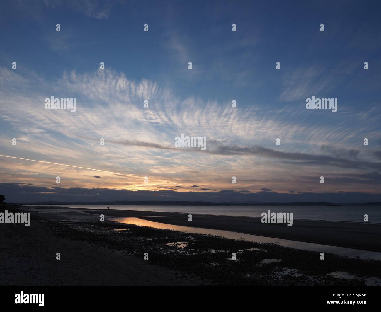 Low tide at Nairn Central Beach, on a summers evening with the sun ...