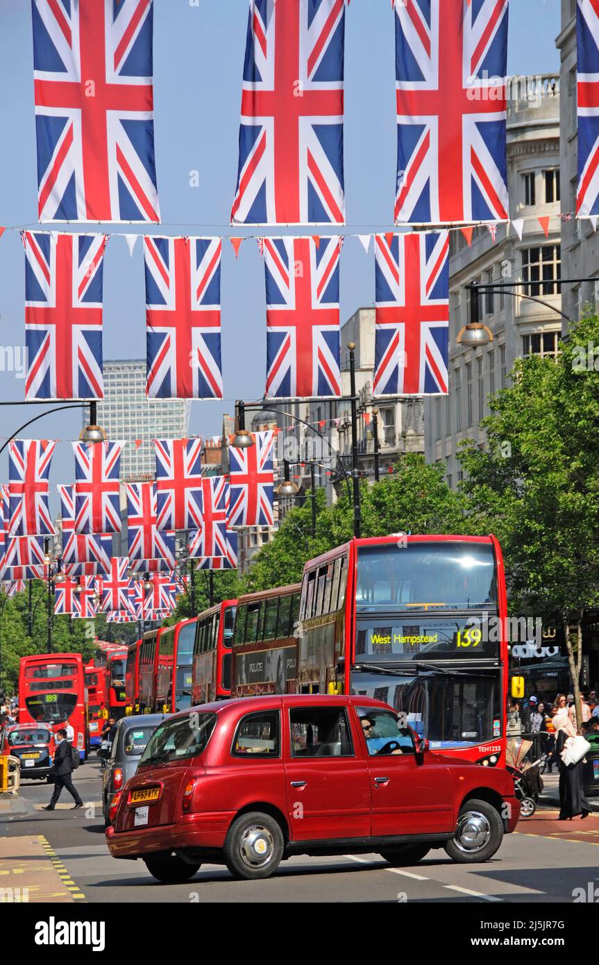 Taxi cab U turn in Oxford Street West End London Union Jack flags for ...
