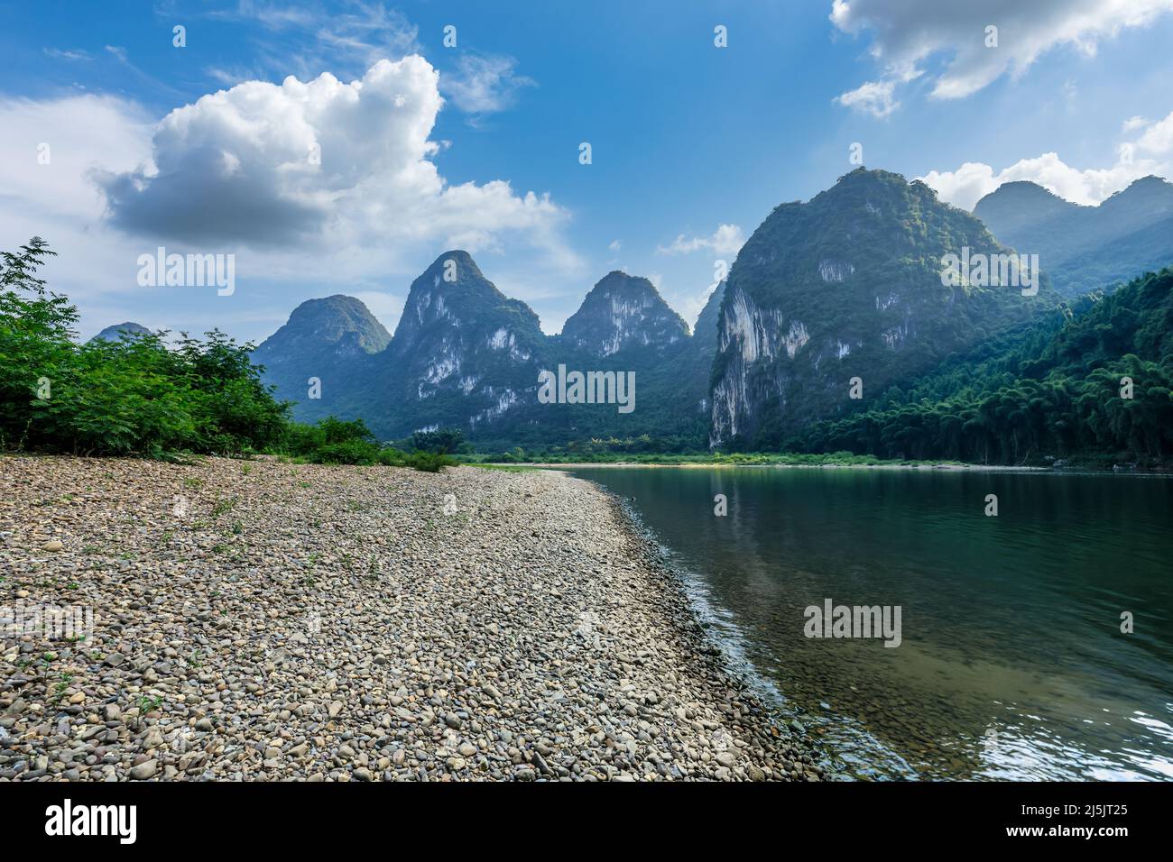 Beautiful mountains and pebble beach with river in Guilin at sunrise ...