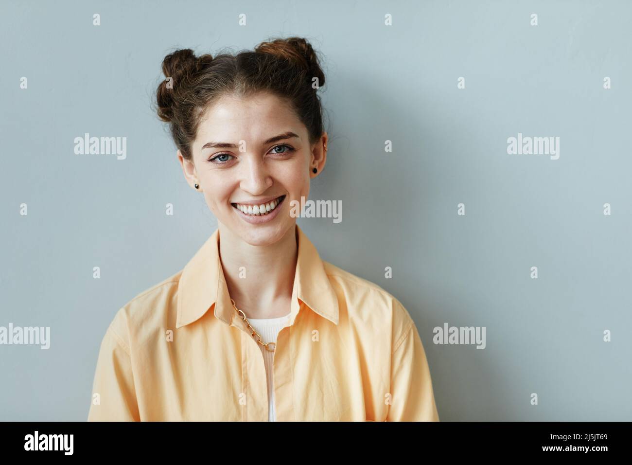 Minimal Portrait Of Cheerful Young Woman With Genuine Smile Looking At