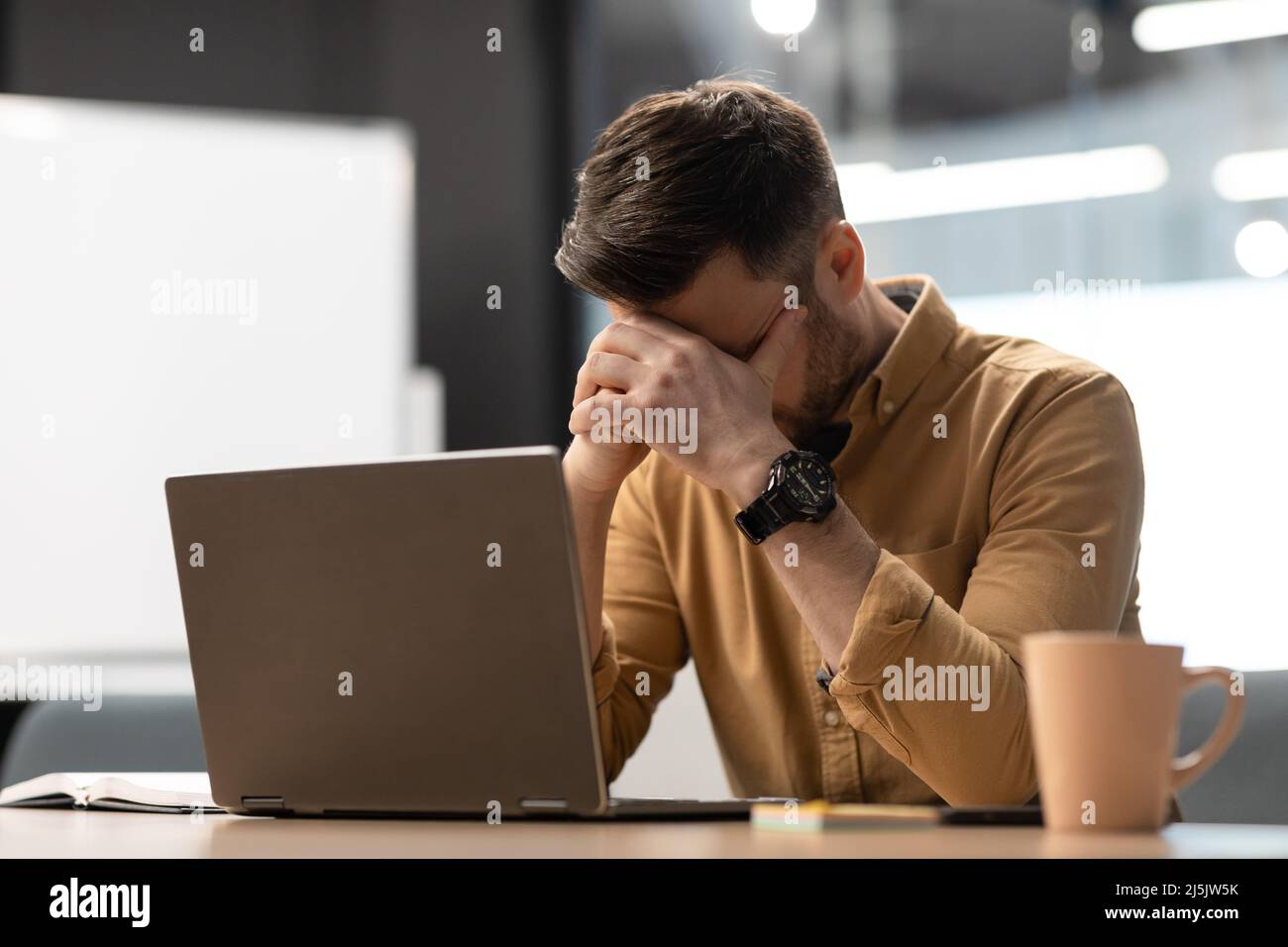 Desperate Businessman Near Laptop Covering Face Having Problem In ...